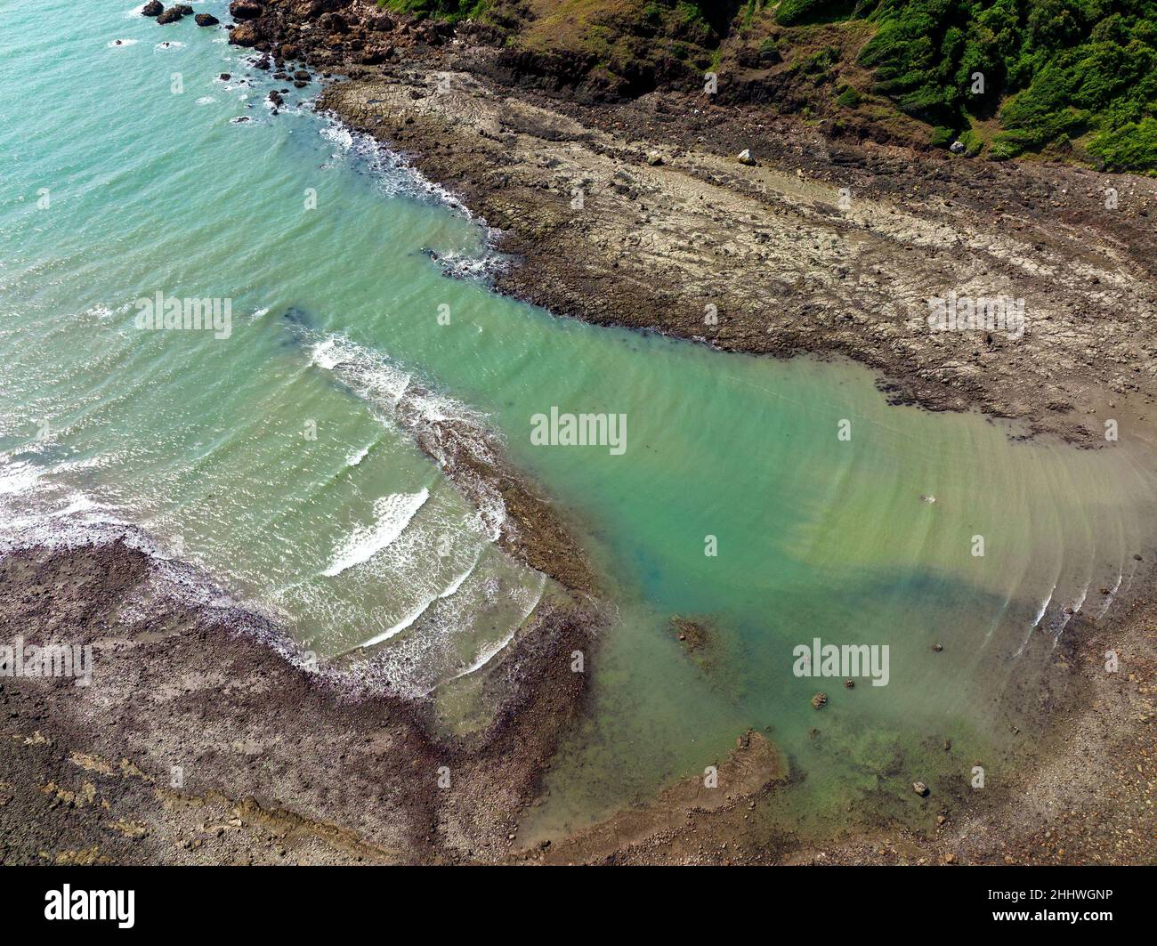Drone view of an incoming tide on a muddy beach Stock Photo - Alamy