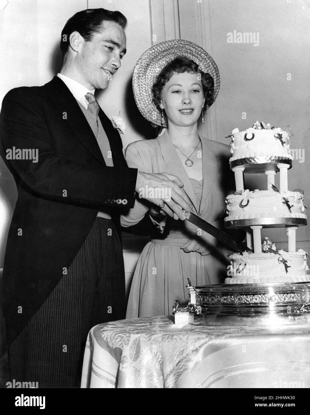 Actor Richard Todd with his bride Catherine Bogle cutting the cake on ...