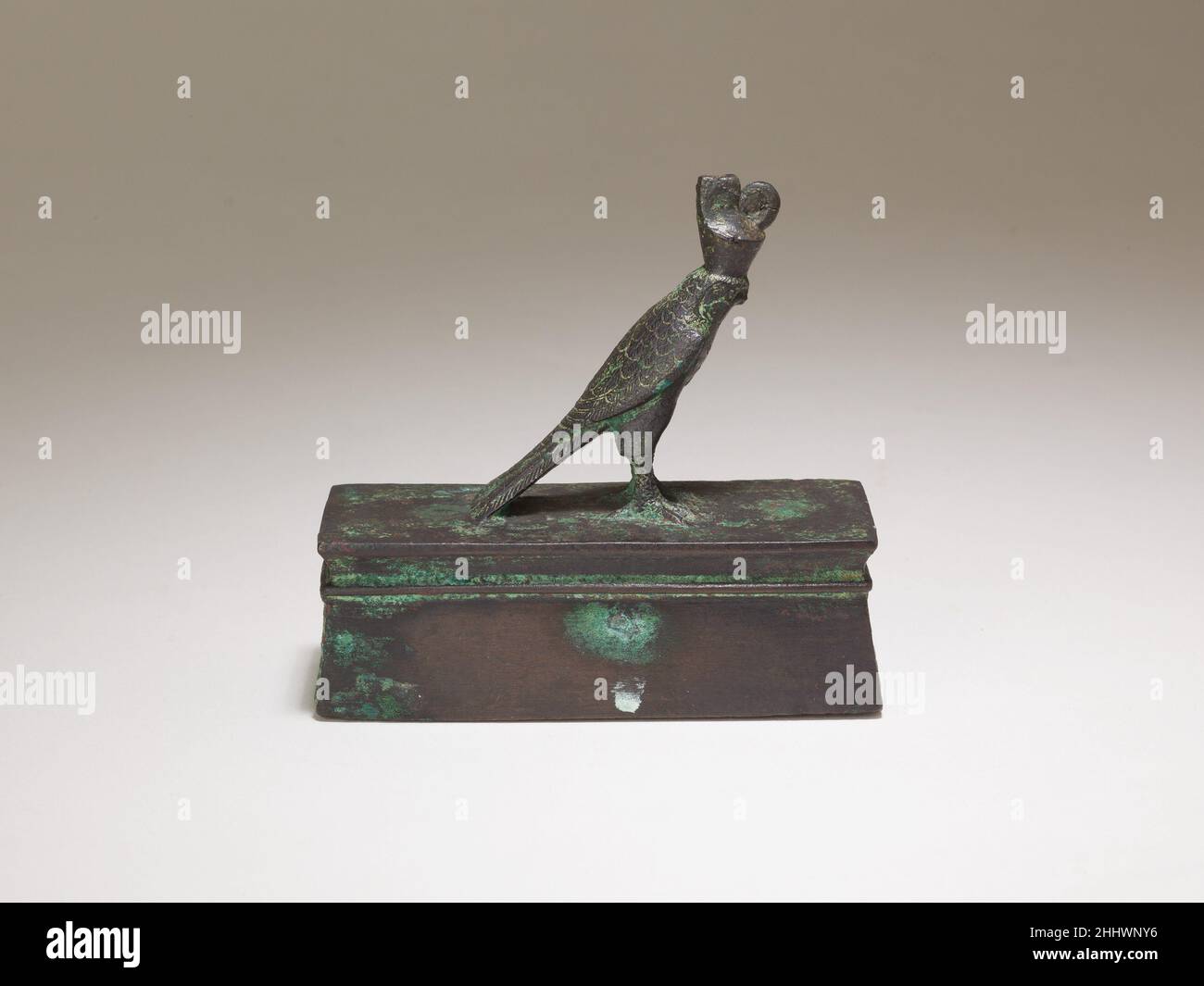 Falcon in double crown surmounting a shrine form box for an animal ...