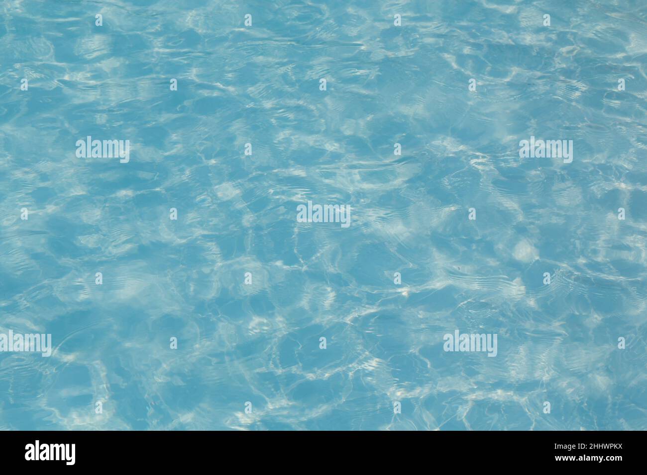 Blue pool water with sun reflections background Stock Photo - Alamy