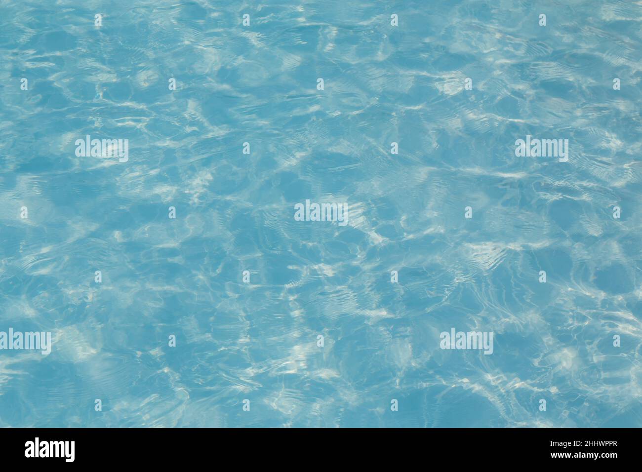 Blue pool water with sun reflections background Stock Photo - Alamy