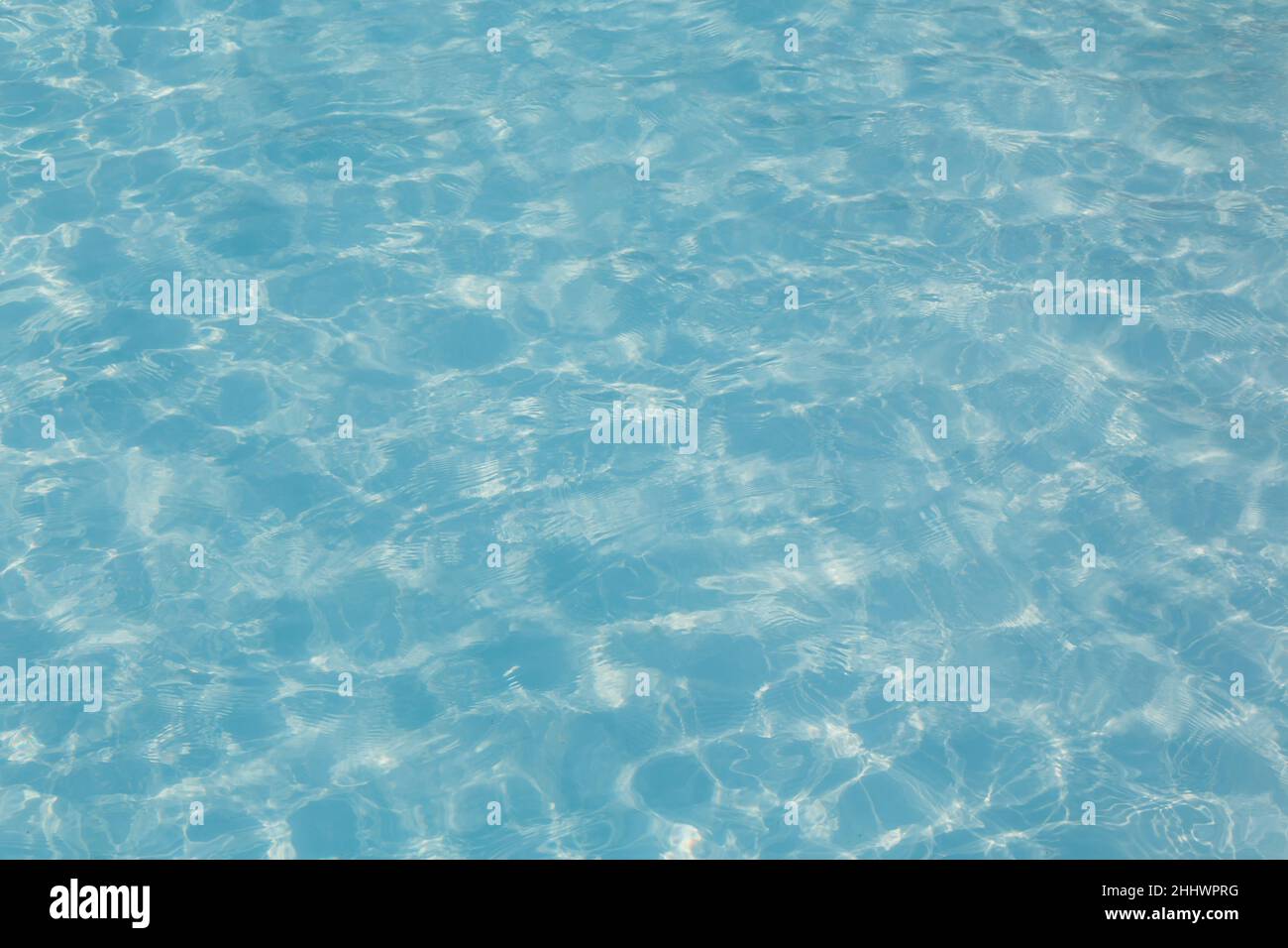 Blue pool water with sun reflections background Stock Photo - Alamy