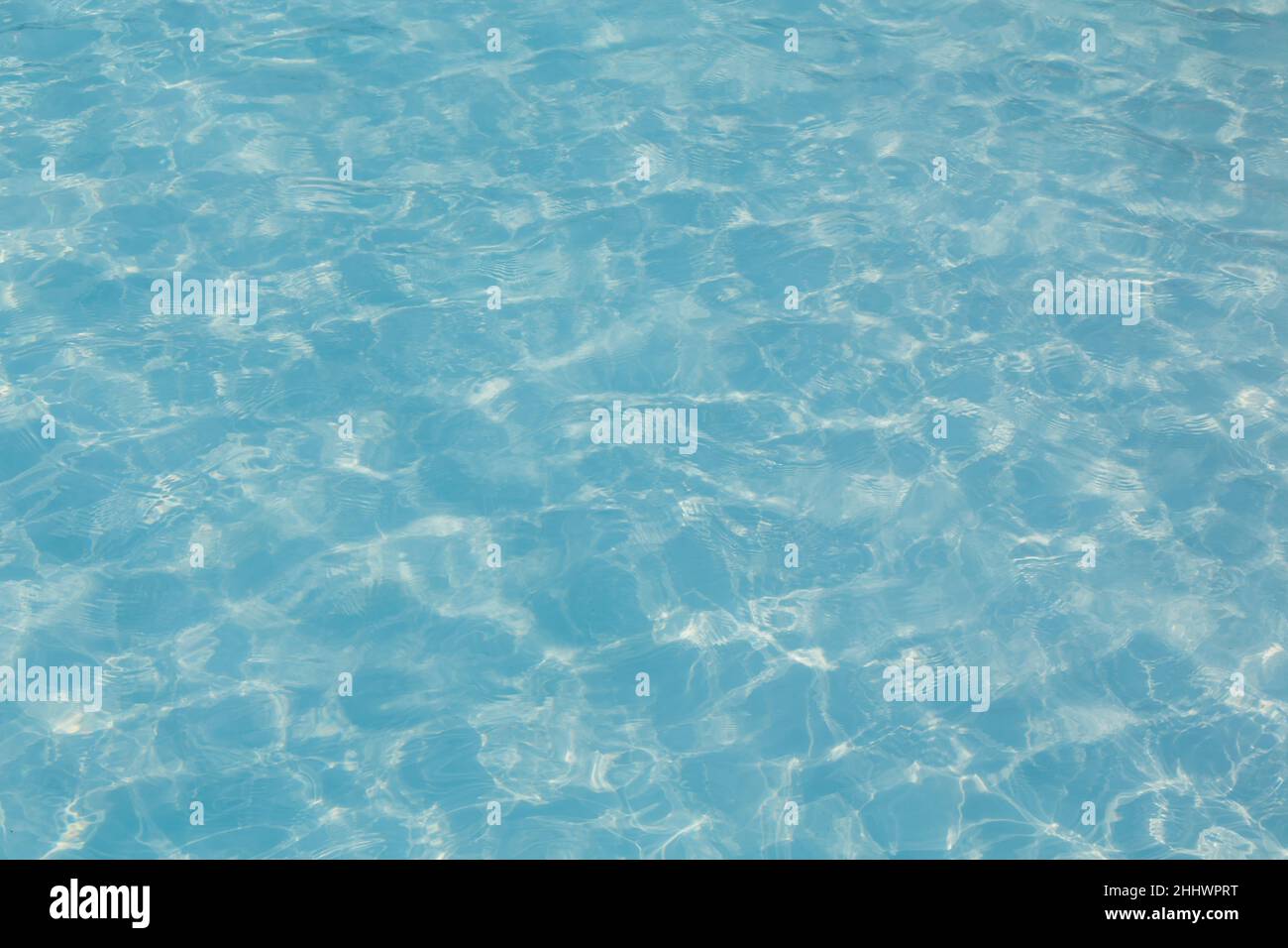 Blue pool water with sun reflections background Stock Photo - Alamy