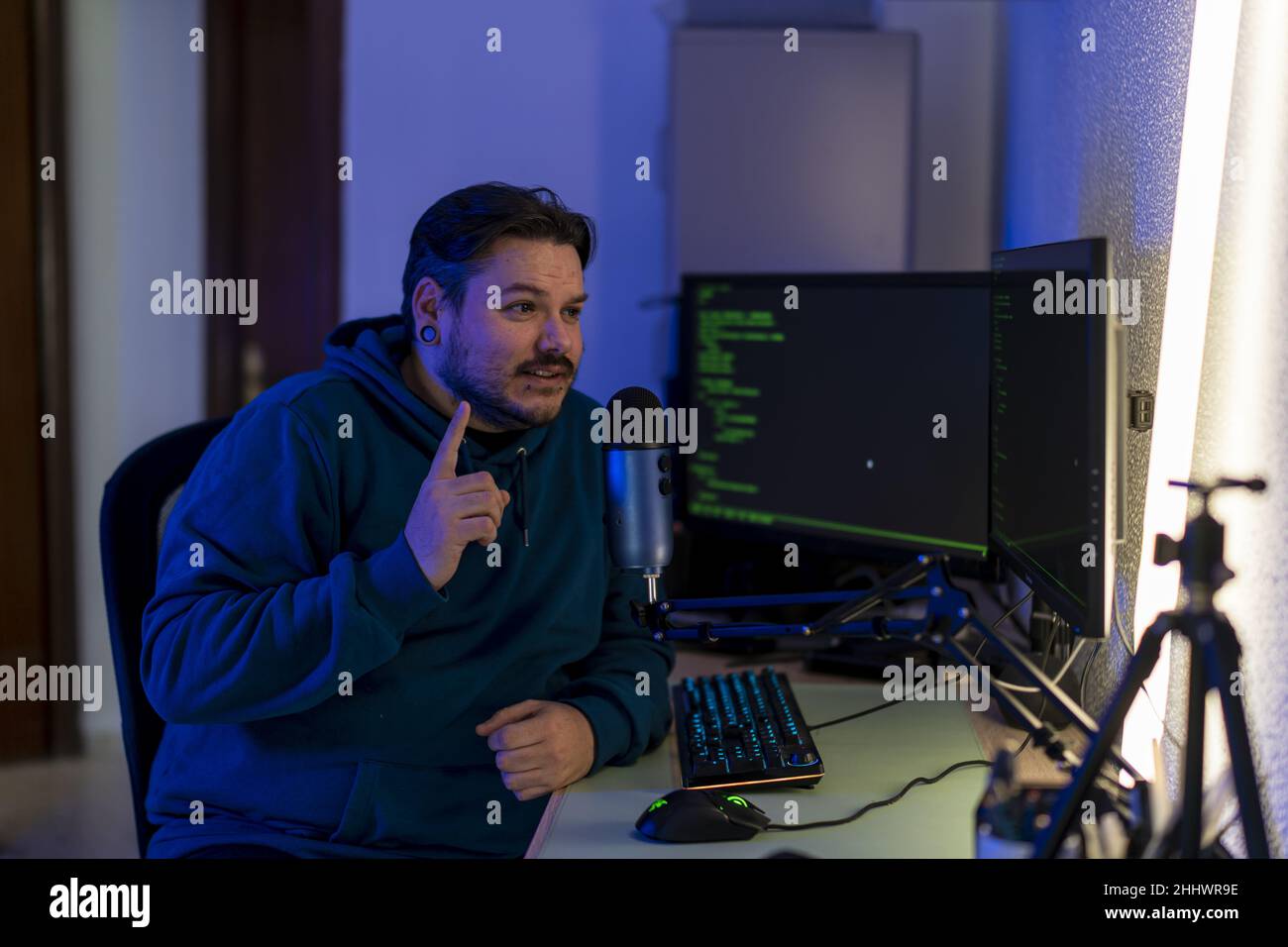 Shallow focus of a computer programming instructor teaching remotely ...