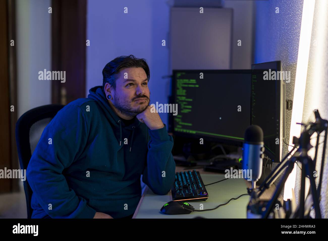 Shallow focus of a computer programmer daydreaming in front of his ...