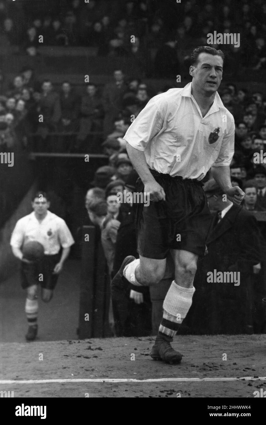 Nat Lofthouse of Bolton Wanderers and England running on to the pitch ...