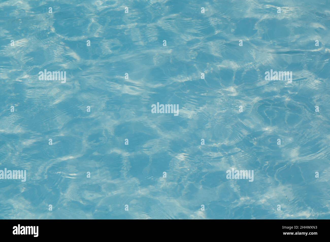 Blue pool water with sun reflections background Stock Photo - Alamy