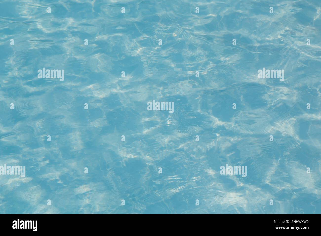 Blue pool water with sun reflections background Stock Photo - Alamy