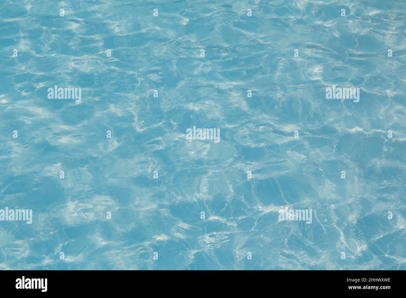 Blue pool water with sun reflections background Stock Photo - Alamy