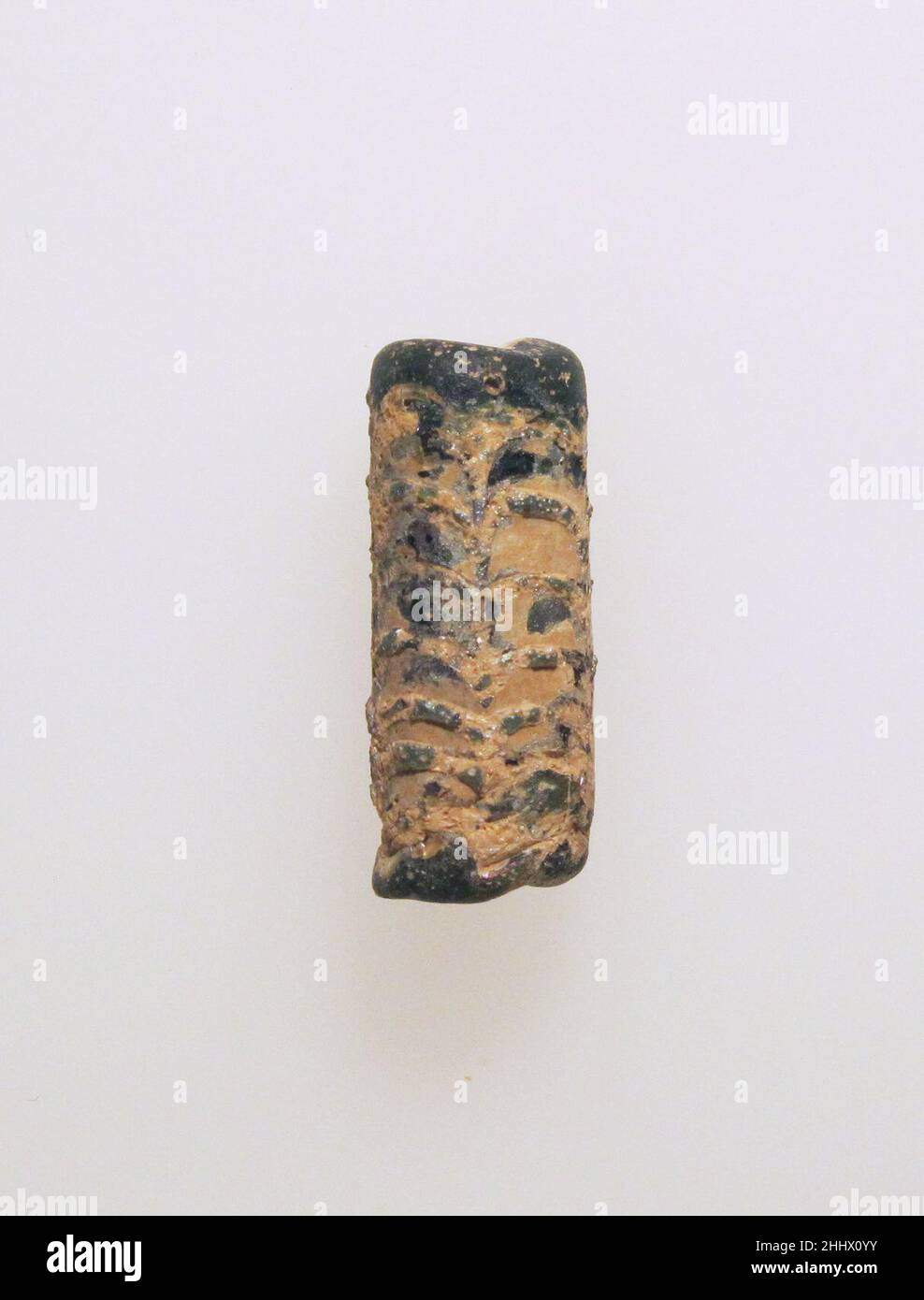 Glass bead Cylindrical glass bead, green and white in color.. Glass ...