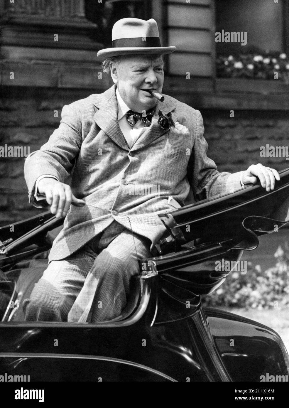 Winston Churchill smiles at the cheering crowds as he leaves the Town ...