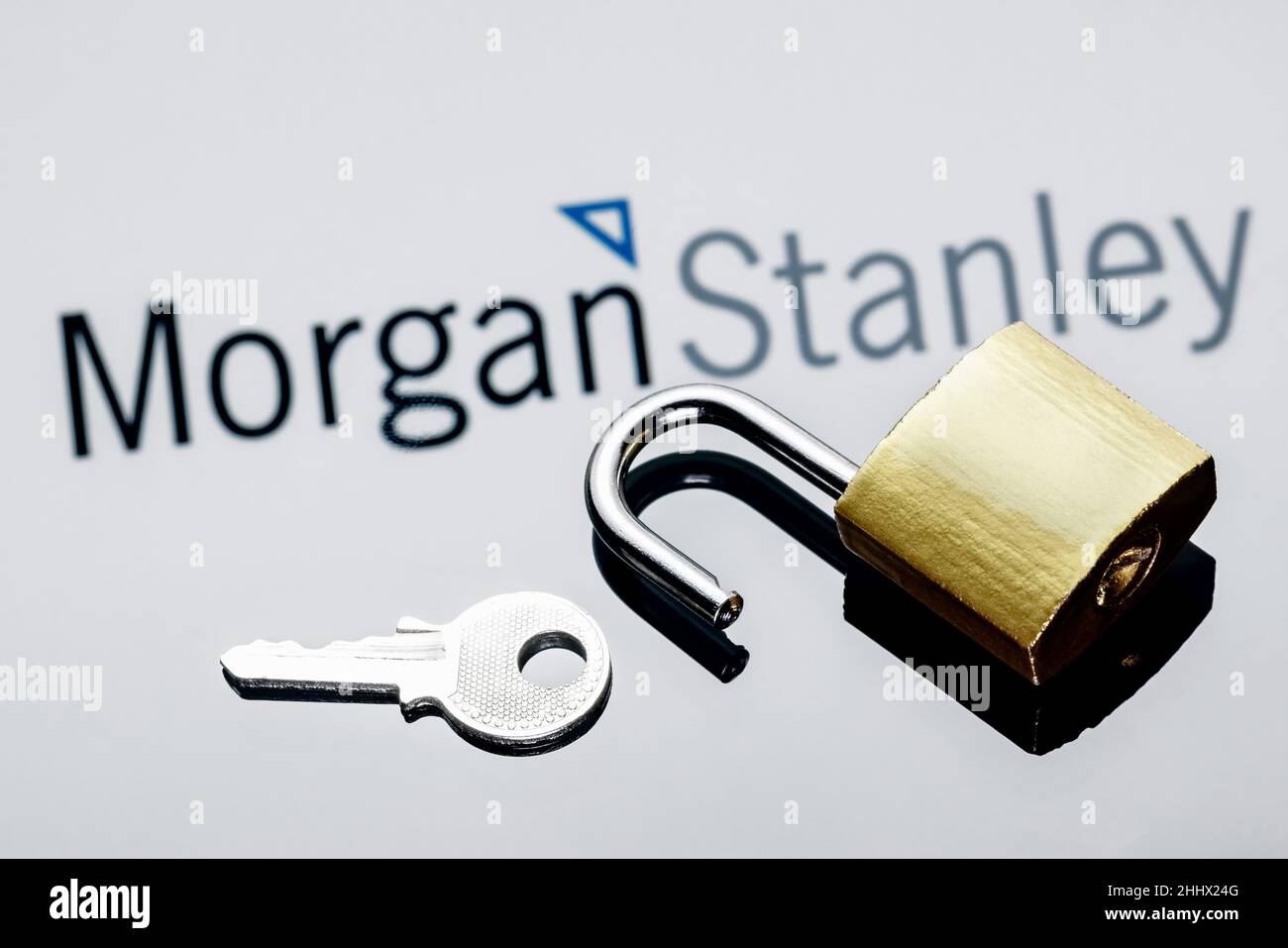 An open security lock and key on background of Morgan Stanley bank logo ...