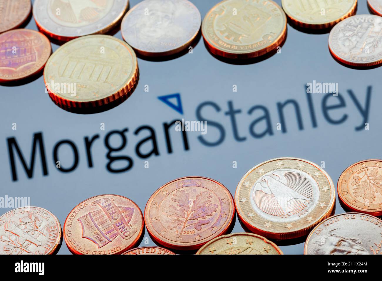 Variety of metal coins on background of Morgan Stanley bank logo Stock ...