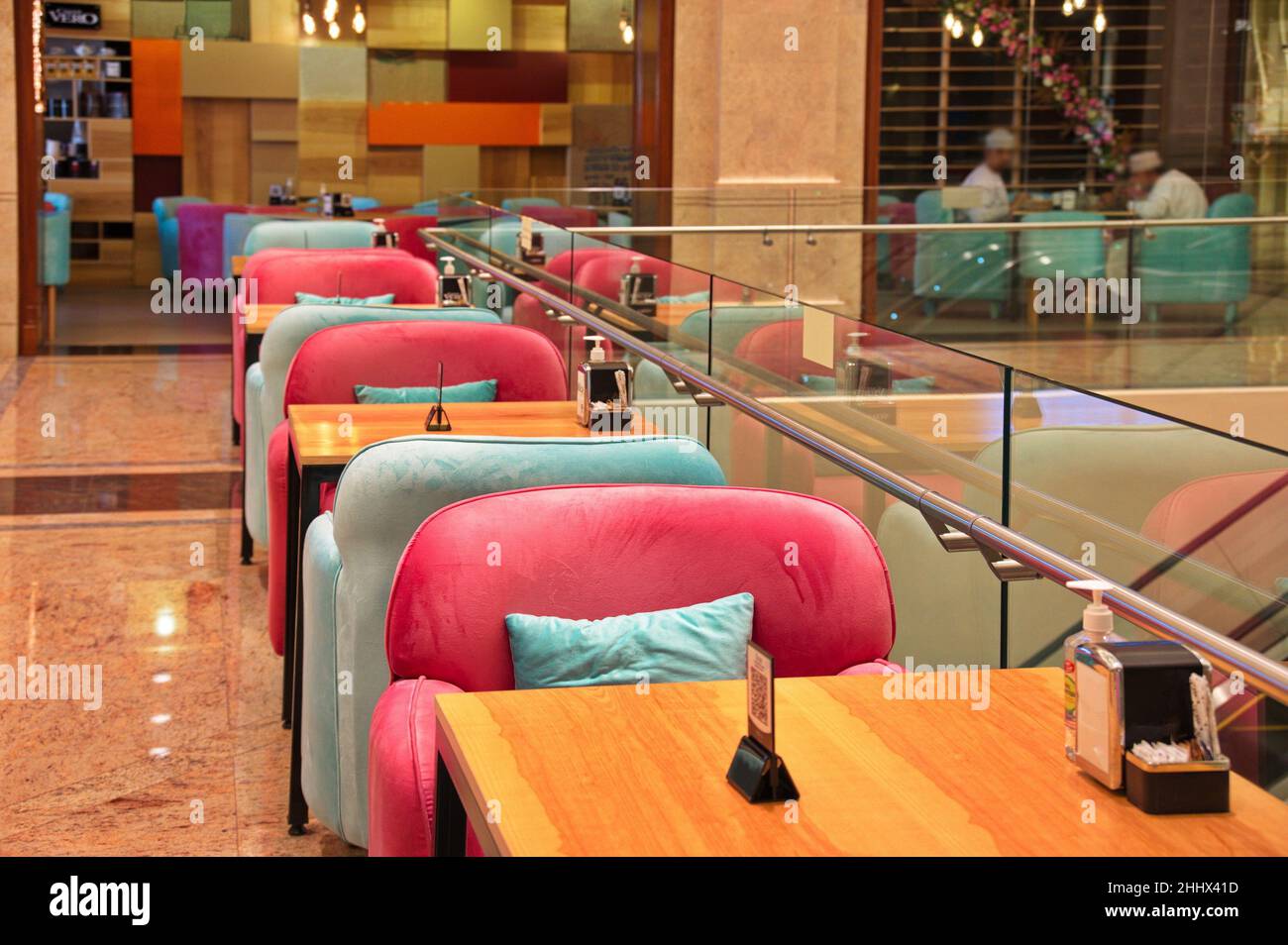 Table and chairs in pastel colors in restaurant Stock Photo - Alamy