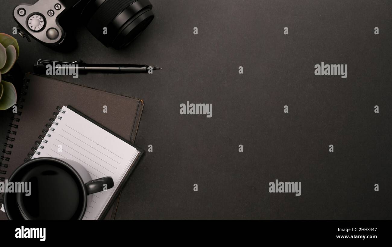 Modern black workspace with photographer accessories and copy space on ...