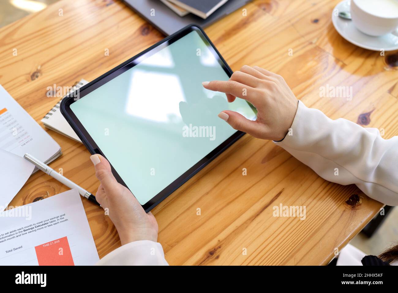 Close-up image of a female hands is tapping on tablet touchscreen ...