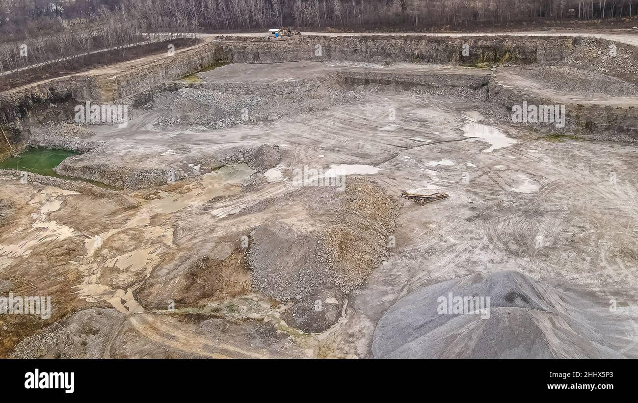 Piles and heaps of gravel and stones with steep walls at the quarry ...