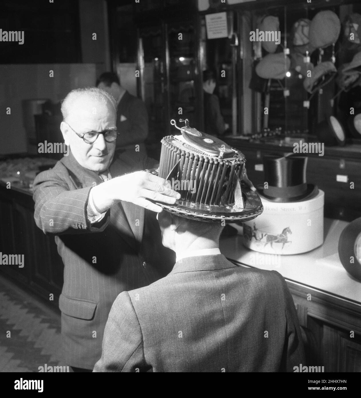 Milliner measuring hat Black and White Stock Photos & Images - Alamy