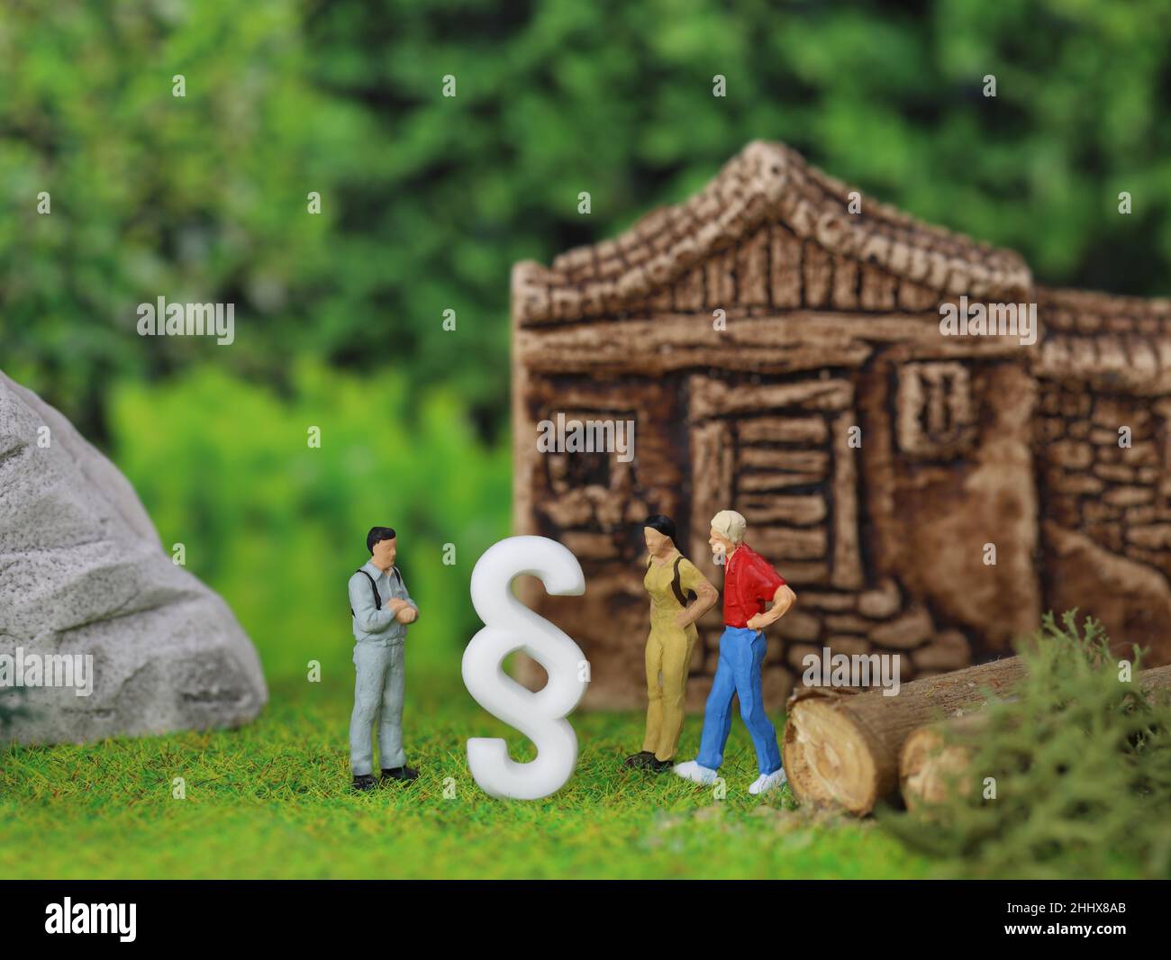 miniature people with white paragraph symbol in front of a house ...
