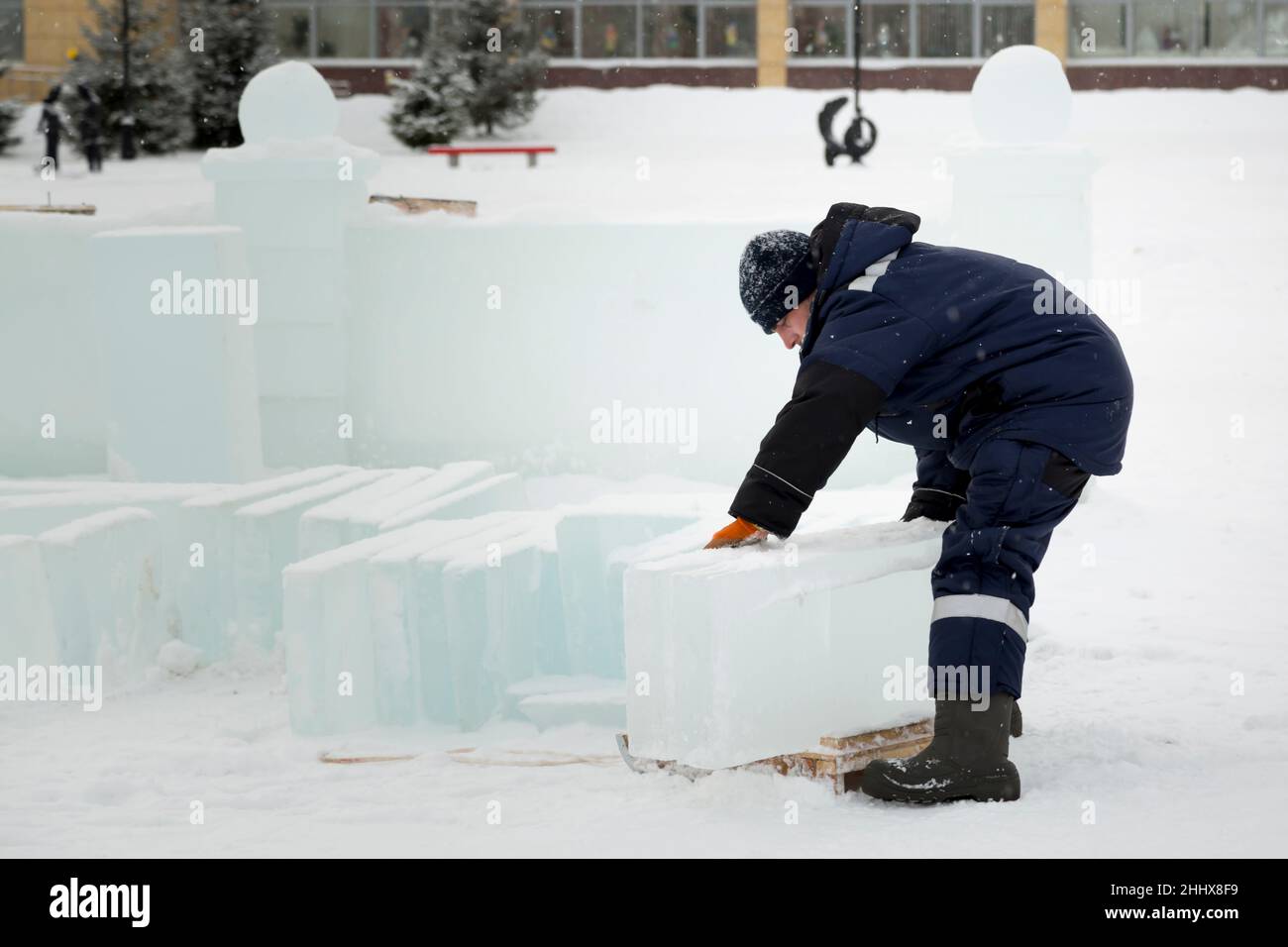 Man loading ice panels onto wooden sled Stock Photo - Alamy