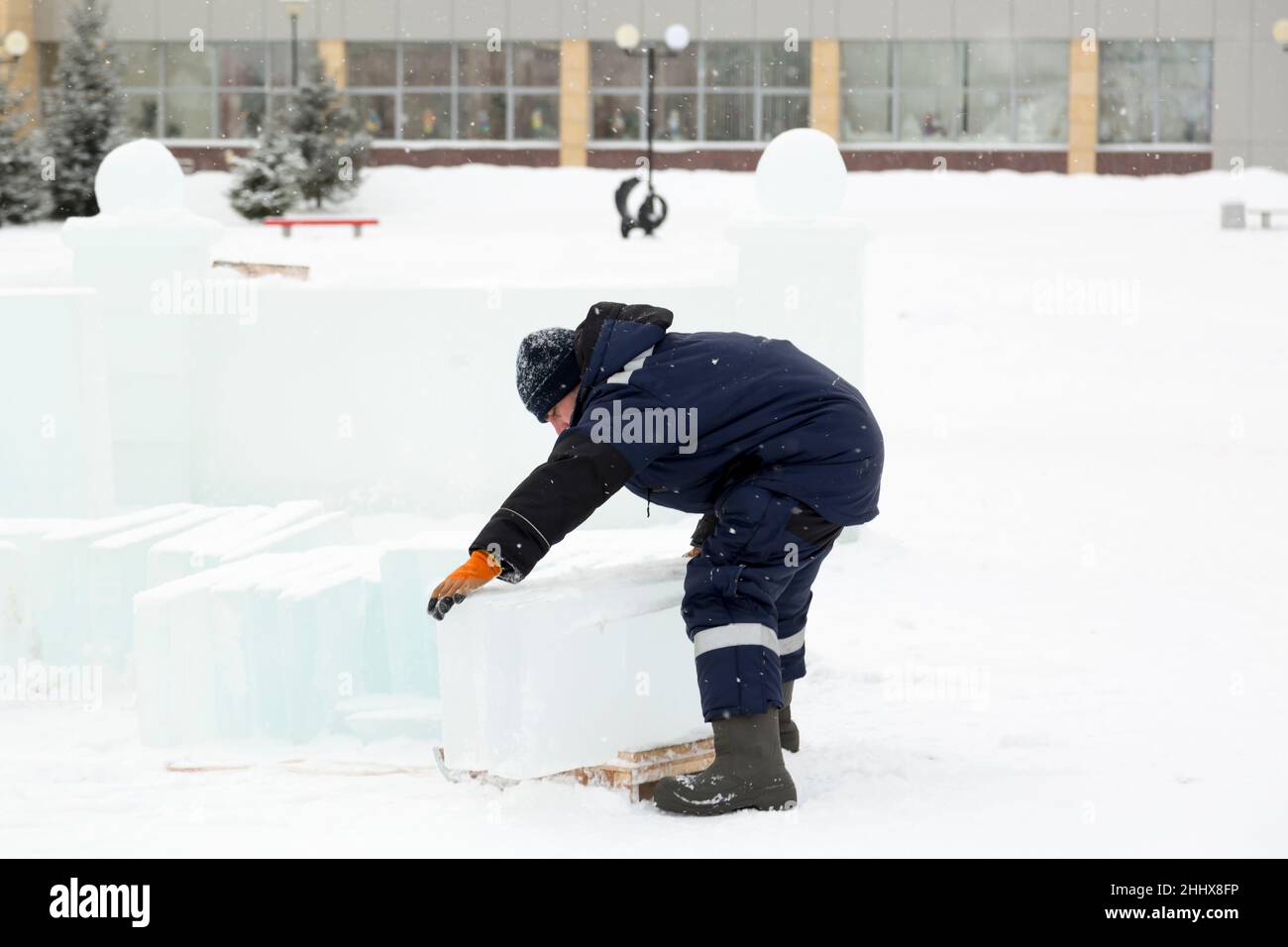 Man loading ice panels onto wooden sled Stock Photo - Alamy