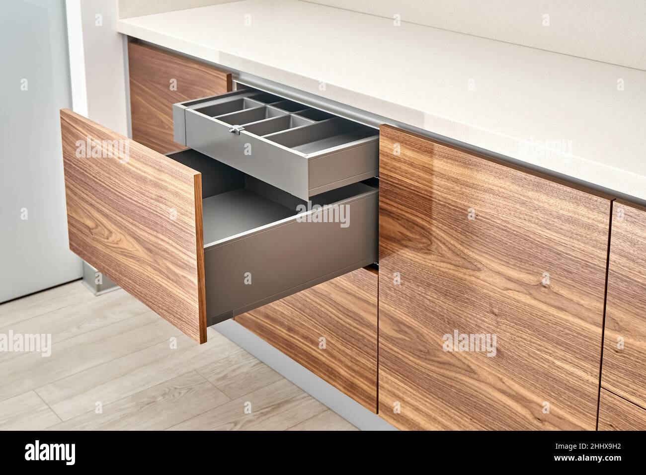 Open drawers of dark grey color with cutlery tray in contemporary ...