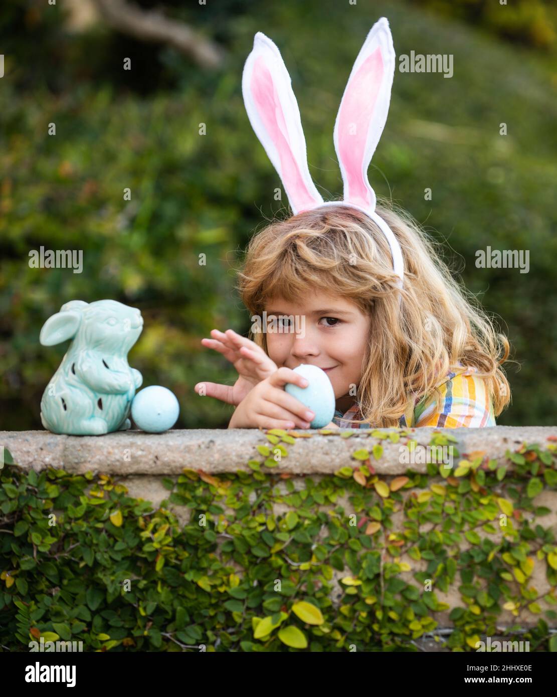 Happy easter day. Child with bunny ears. Children hunting easter eggs ...