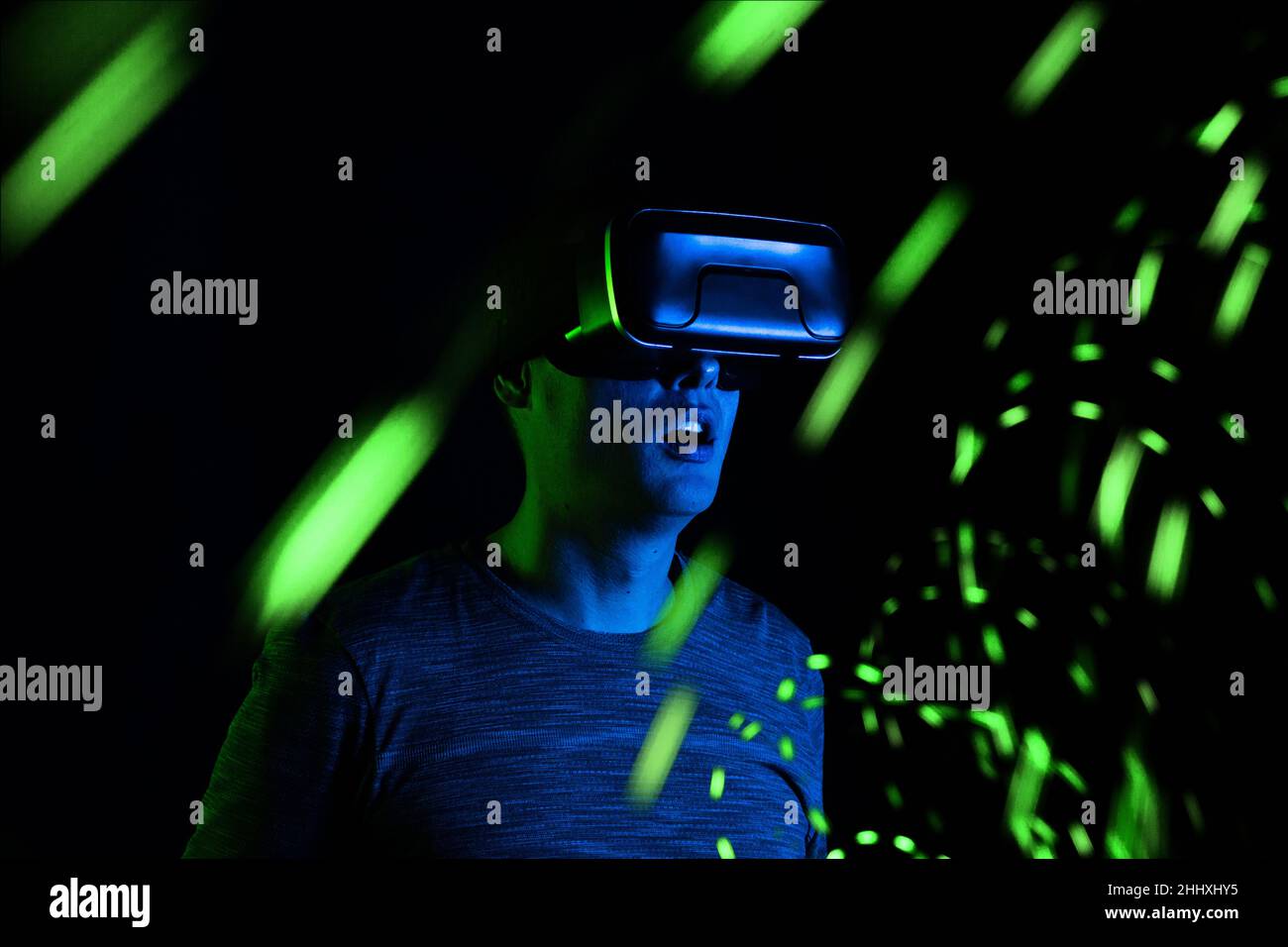 Caucasian male with impression on his face using VR goggles on black ...