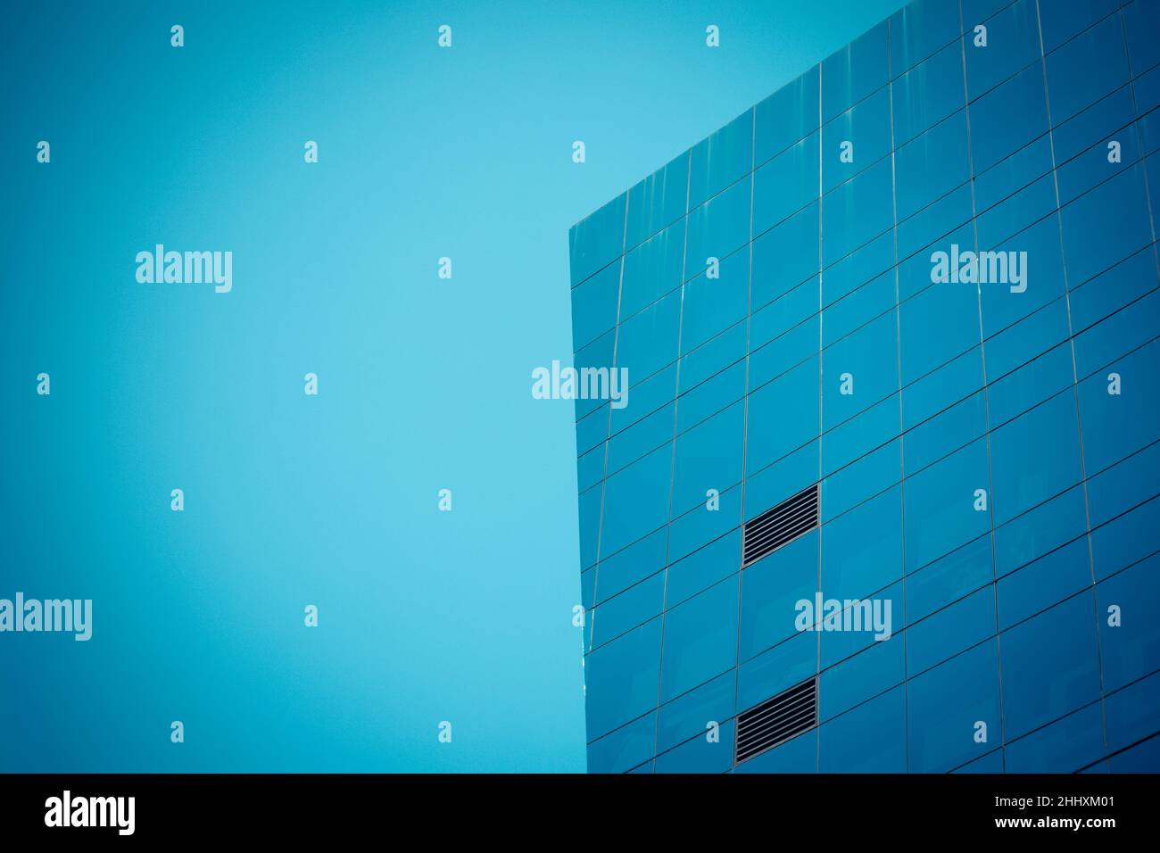 Modern office building with blue glass windows background Stock Photo ...