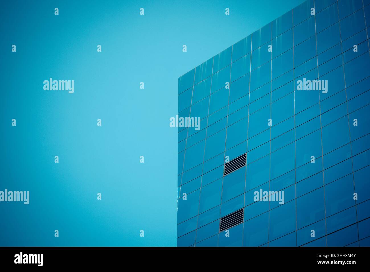 Modern office building with blue glass windows background Stock Photo ...