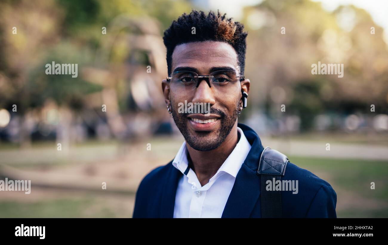 Portrait of hardworking young black man looking at camera in a park ...