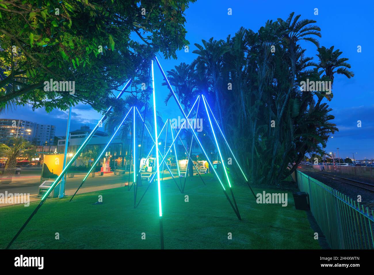 Pyramid-shaped light sculptures in a park at night. Photographed in ...
