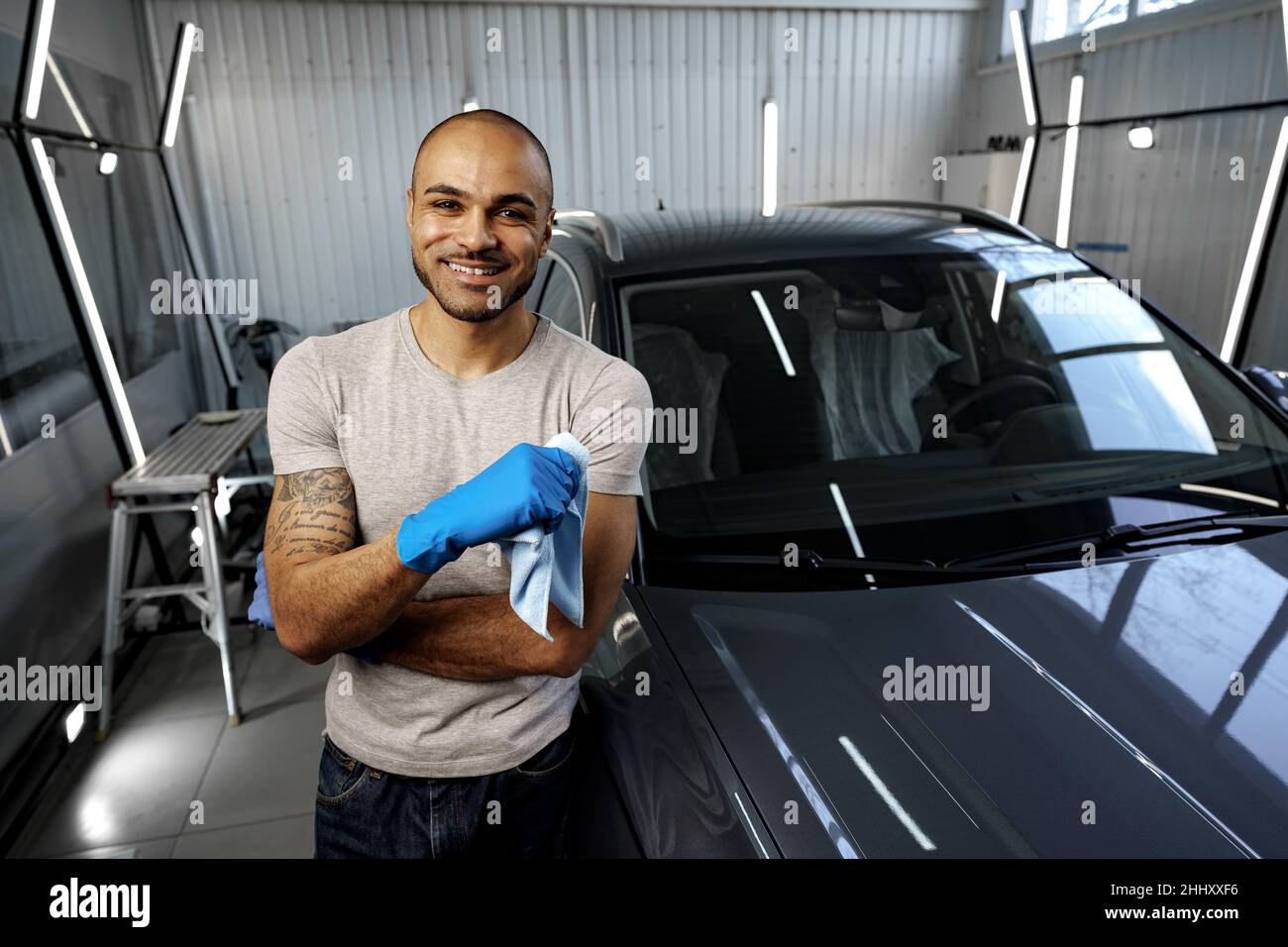Portrait of African American man, car wash detailing service worker ...