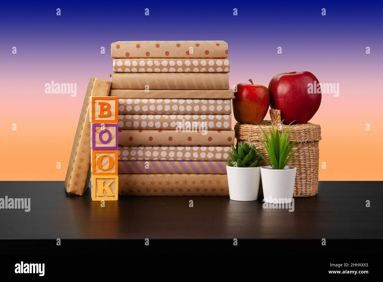 Stack of books on black wooden table Stock Photo - Alamy