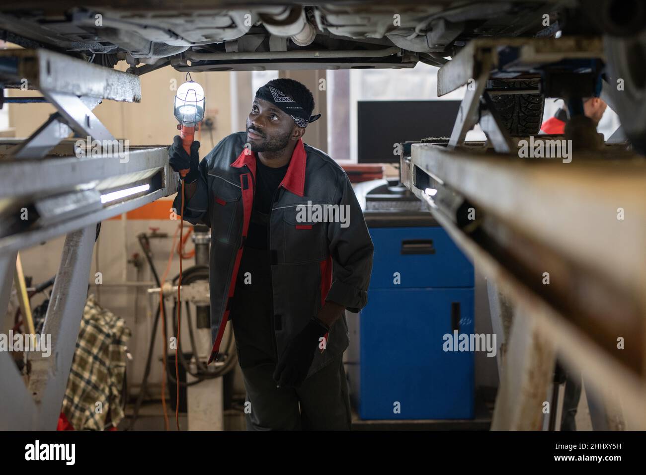 Car repairman holding lamp hi-res stock photography and images - Alamy