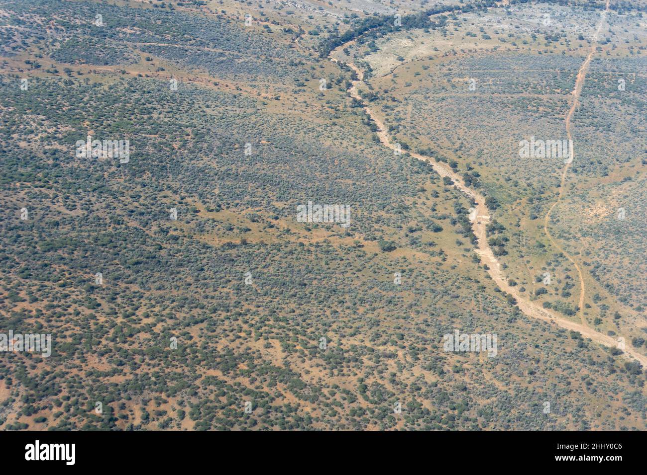 Aerial view Namibian landscape with dusty roads meets dry riverbed in ...