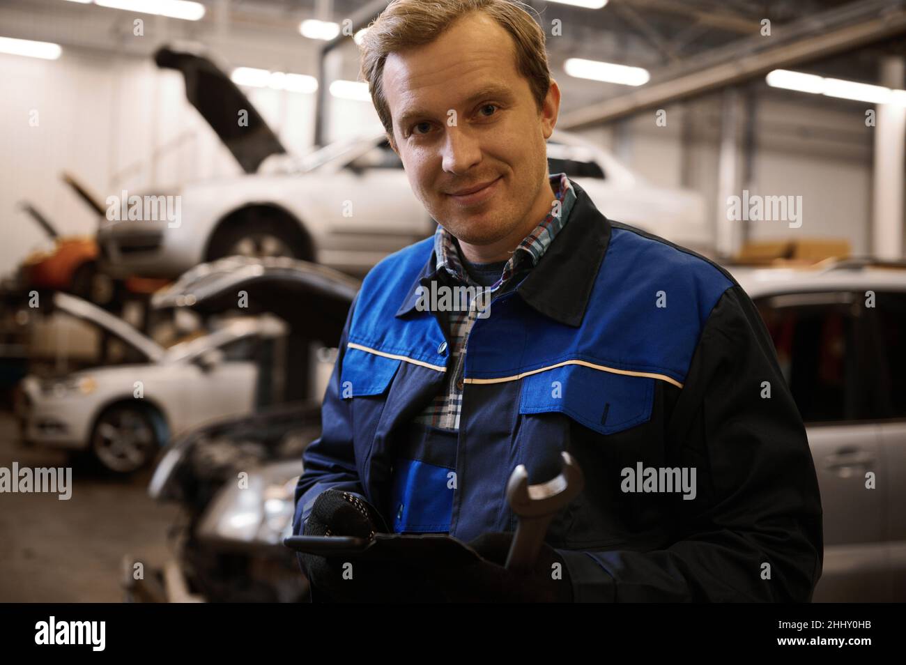 Handsome smiling Caucasian auto mechanic, car engineer, technician in ...