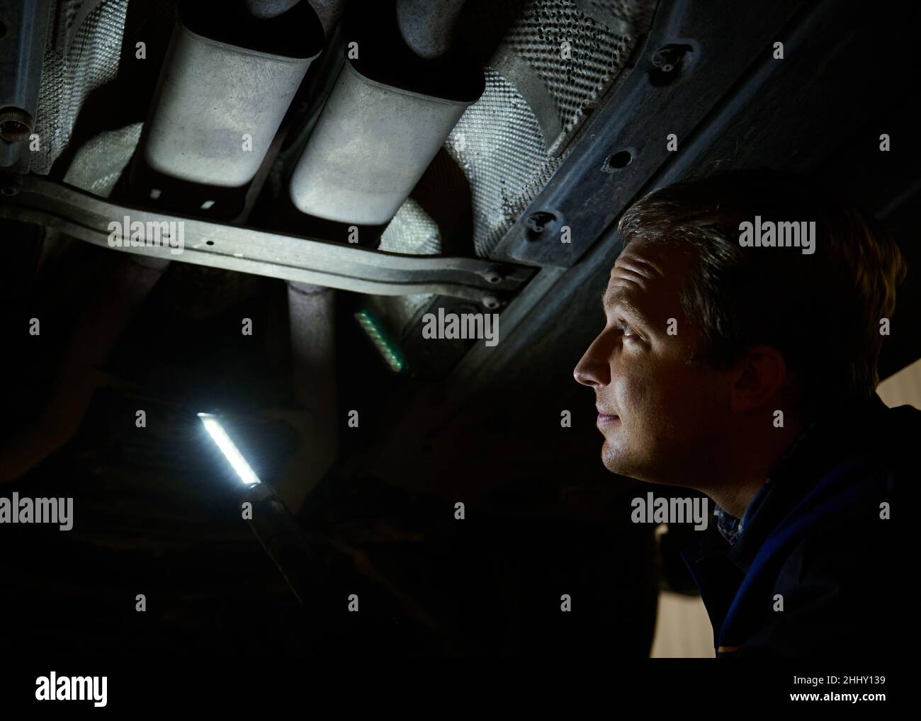 Technician checking modern car at automobile repair shop. Auto mechanic ...