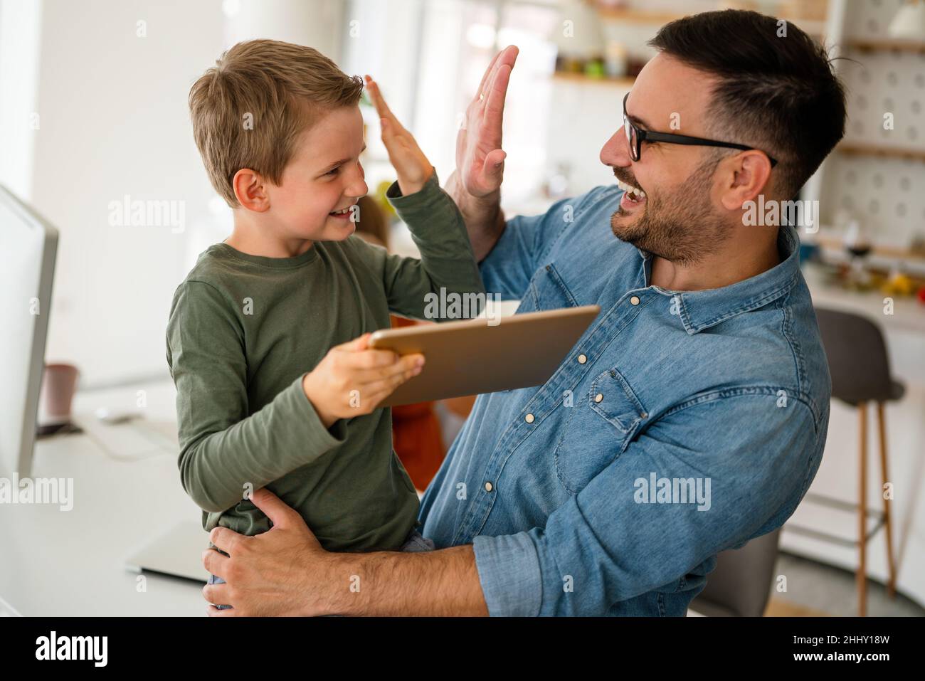 Father and child using digital tablet for e-learning. Education home digital device kid concept ...