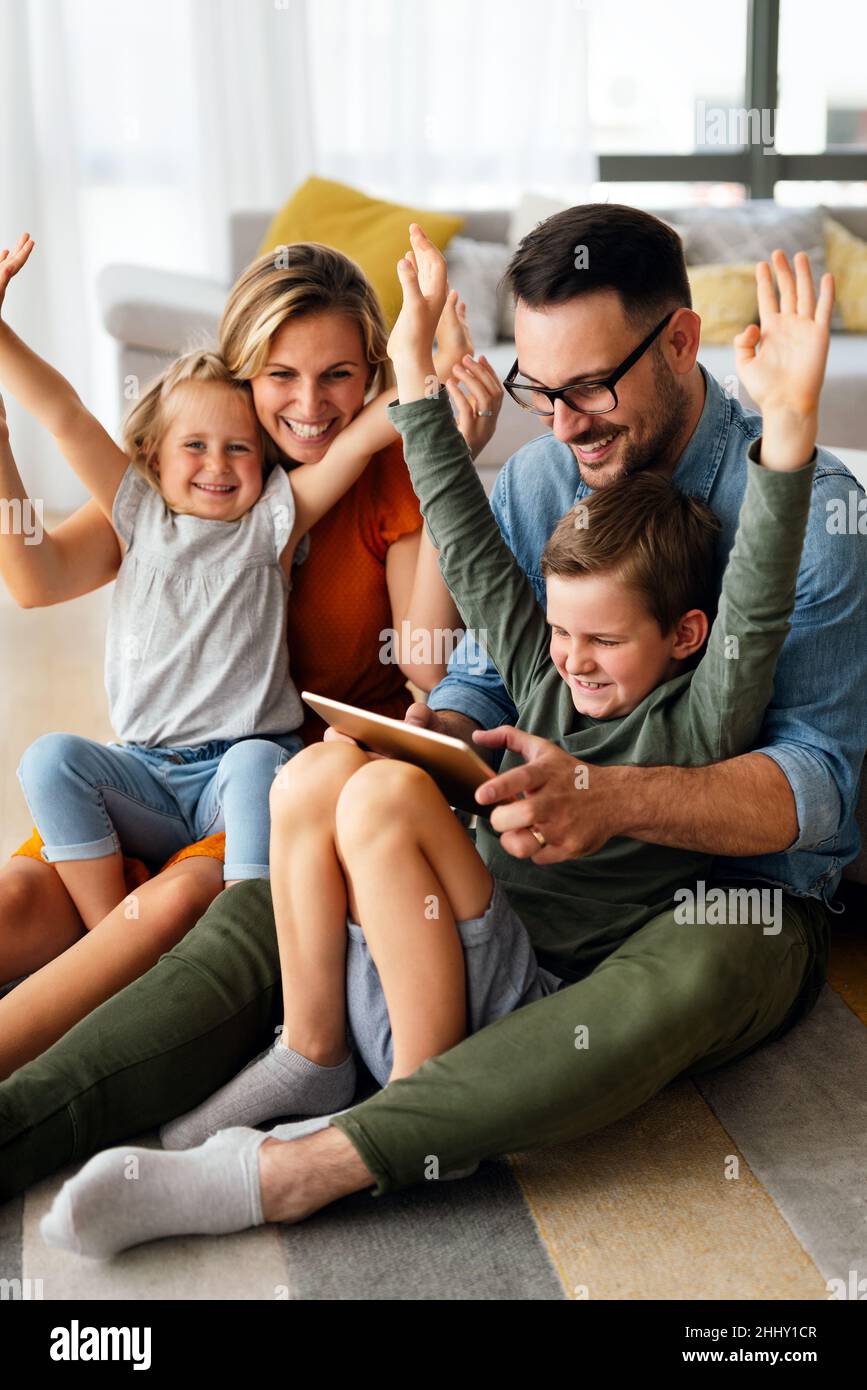 Device technology family online education concept. Happy family with ...
