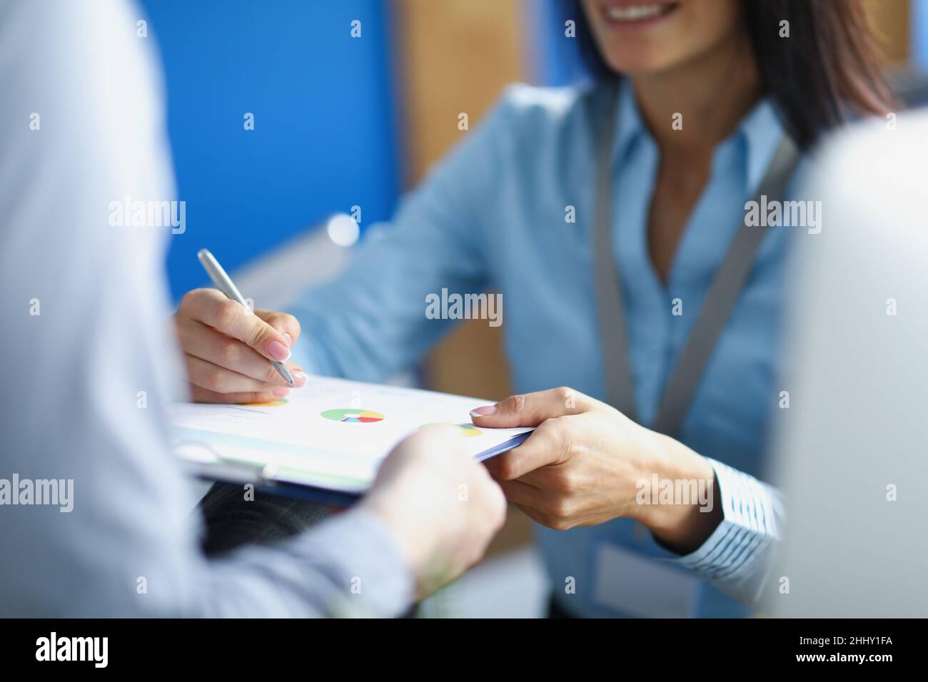 Female worker make correction on business paper with pen Stock Photo ...