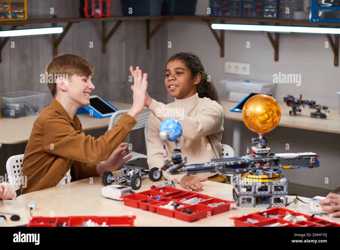 Boy and girl congratulating each other with successful project, they ...