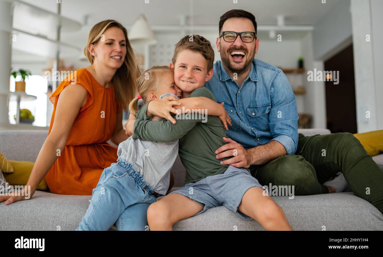 Happy family having fun time at home. Parents playing smiling with ...