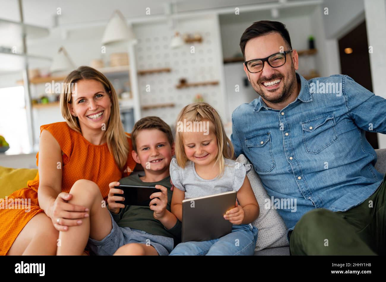 Device technology family online education concept. Happy family with ...
