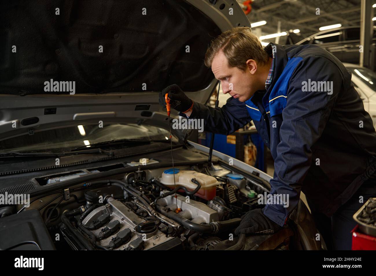 Concentrated Caucasian young man, car engineer technician mechanic in ...