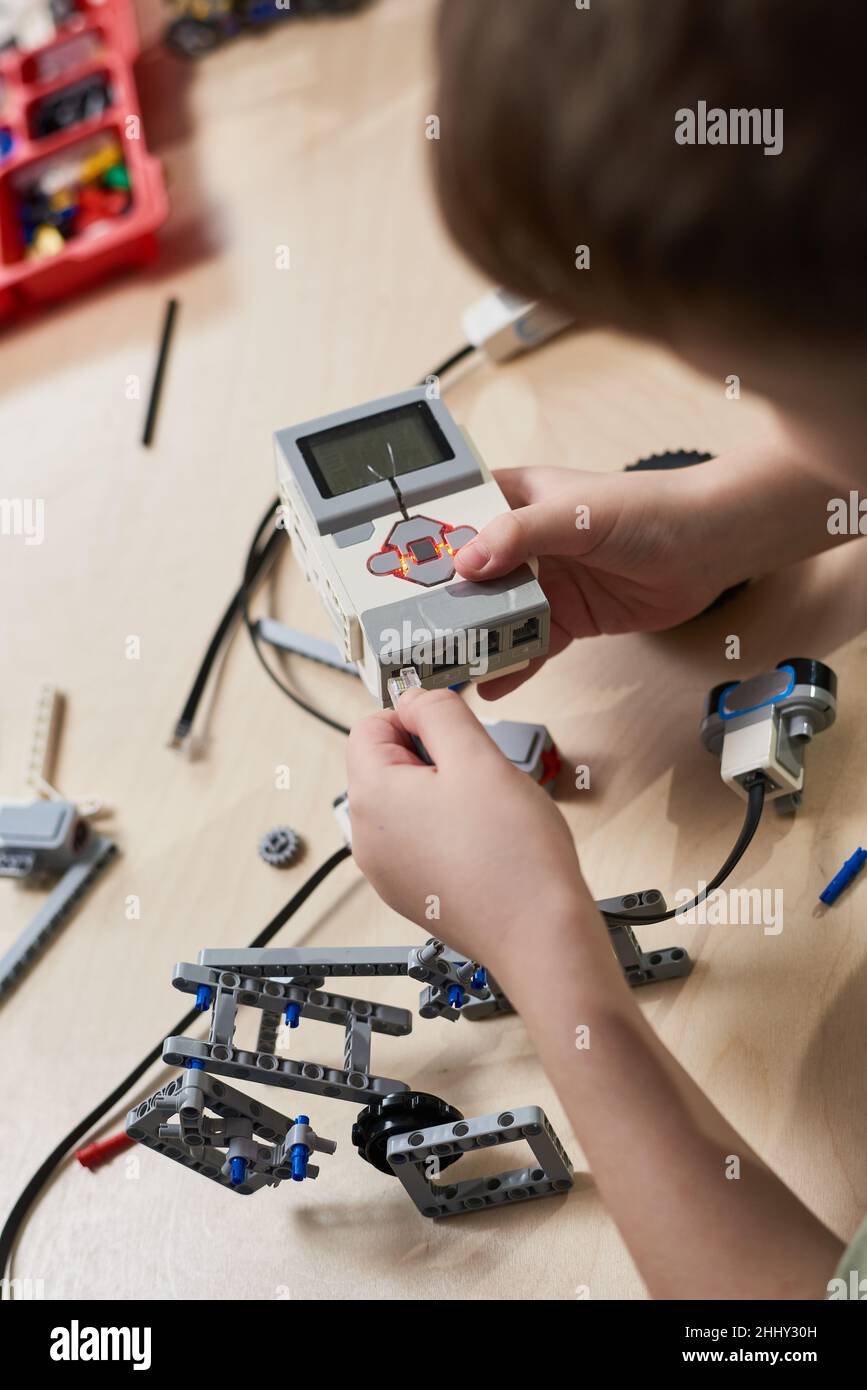 Close-up of boy building robot constructor from the plastics details ...