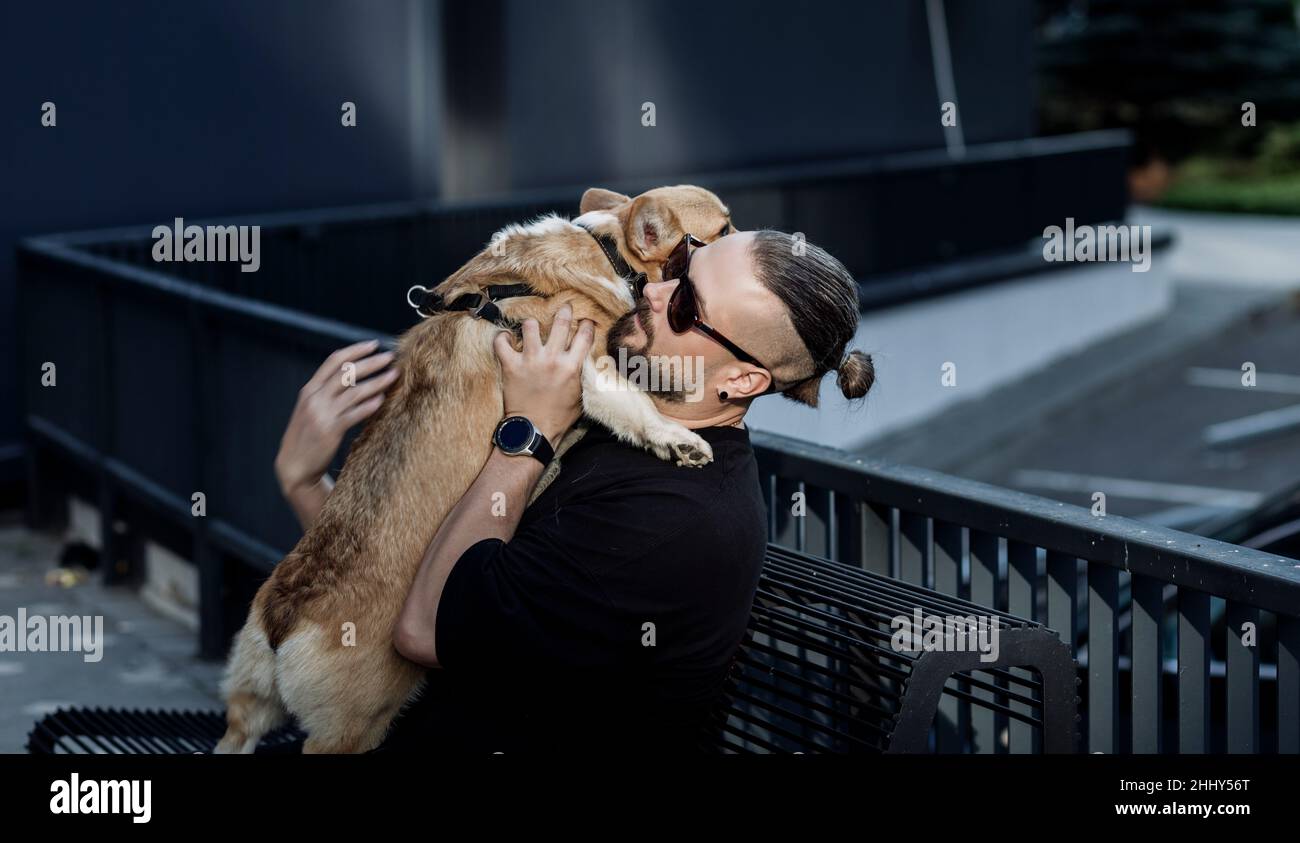 Handsome man hugging fluffy dog. Concept of care, education, raising of ...