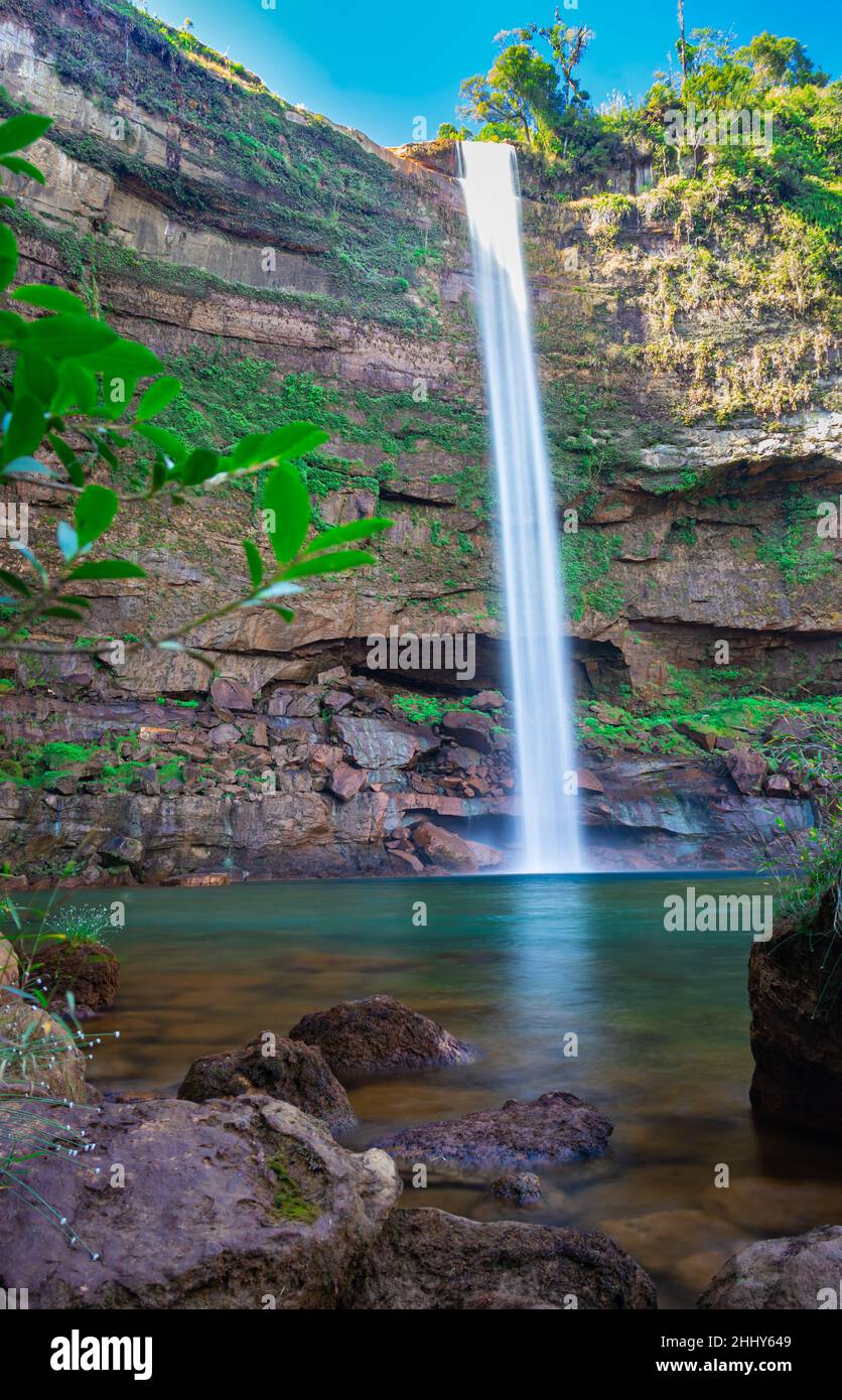 waterfall falling streams from mountain top with reflection from ...