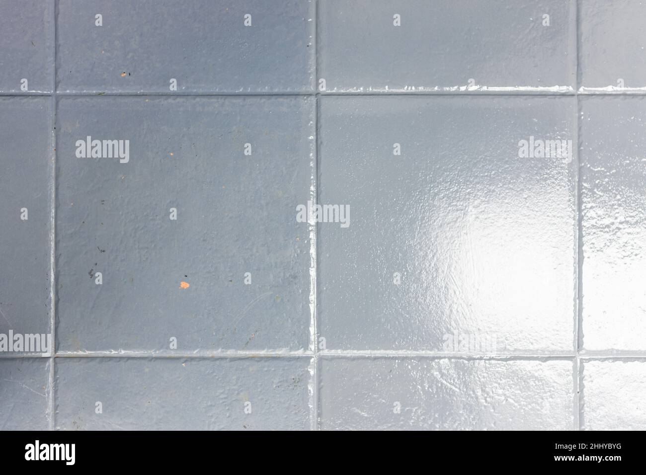 scratched chipped floor tiles getting a fresh coat of paint, concept of ...