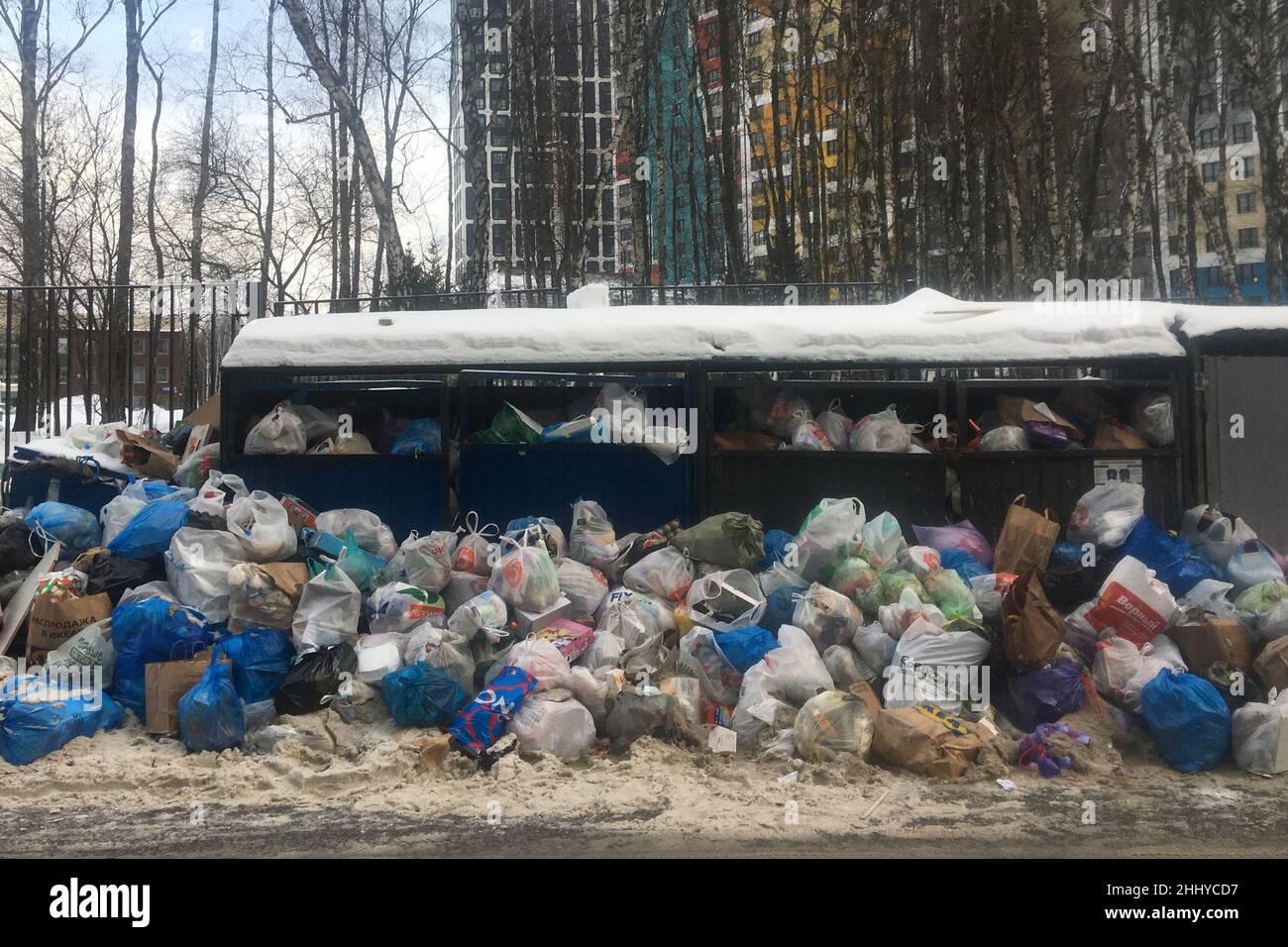 Garbage cans near littered with household garbage in plastic bags ...